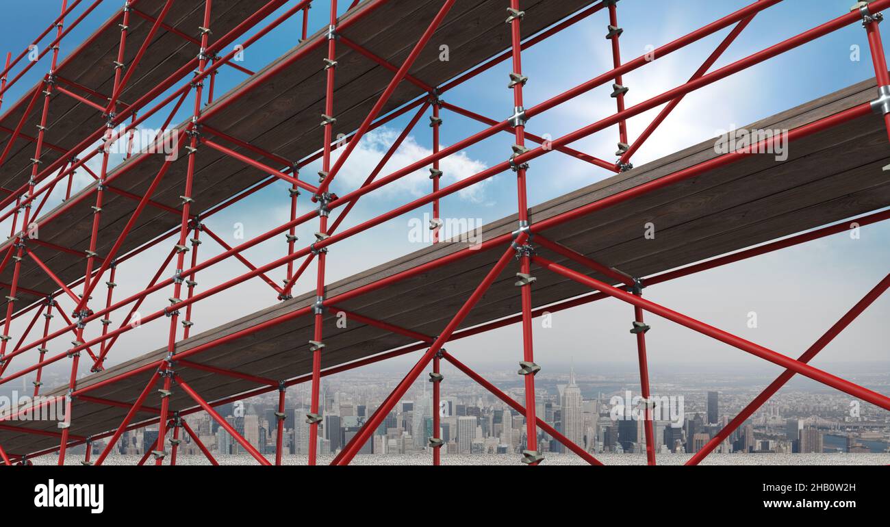 Construction scaffolding over a cityscape against clouds in the blue ...