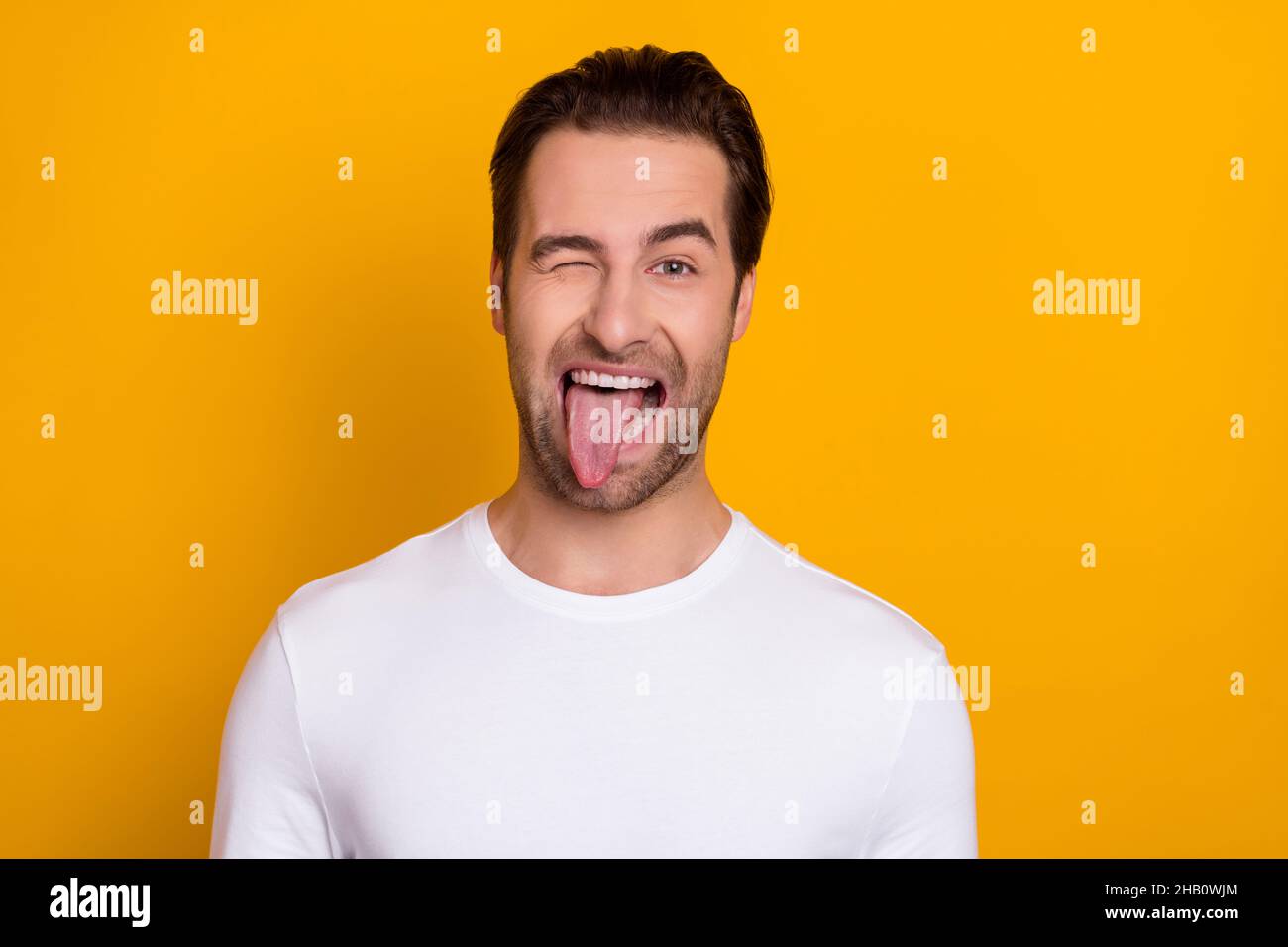 Photo of youth guy have fun blink eye stick-out comic fool silly ...