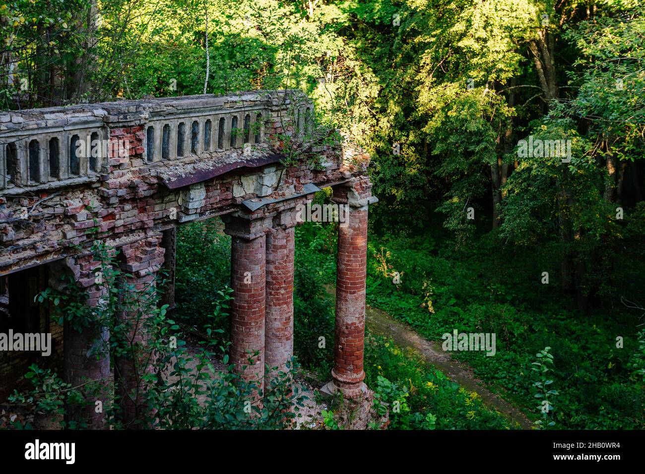 Old ruined overgrown balcony of abandoned mansion. Former manor ...