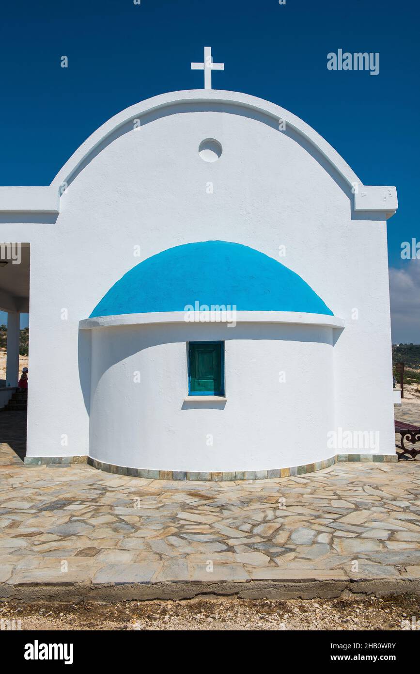 Traditional Greek white chapel with a blue roof on the seaside. Agioi ...