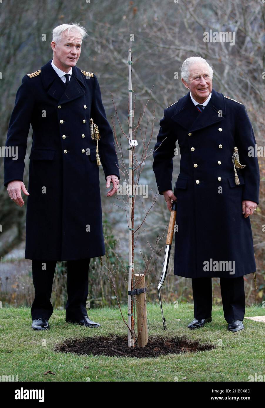 The Prince of Wales (right) plants a tree next to Captain Roger Readwin ...
