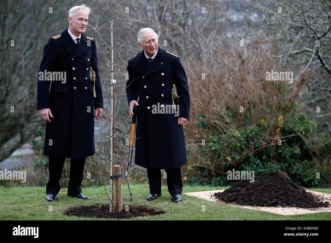 The Prince of Wales (right) plants a tree next to Captain Roger Readwin ...