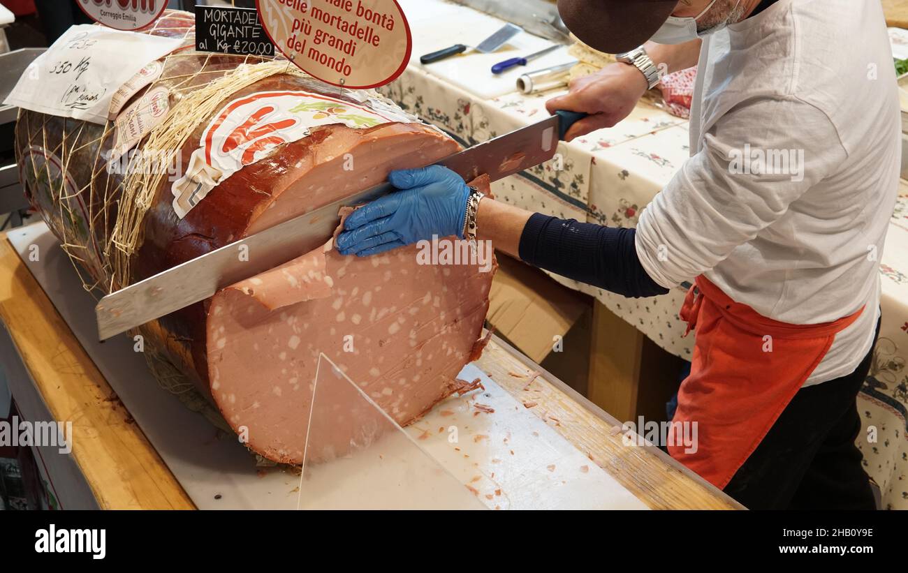 giant Italian mortadella, artisan slices with huge knife Stock Photo ...