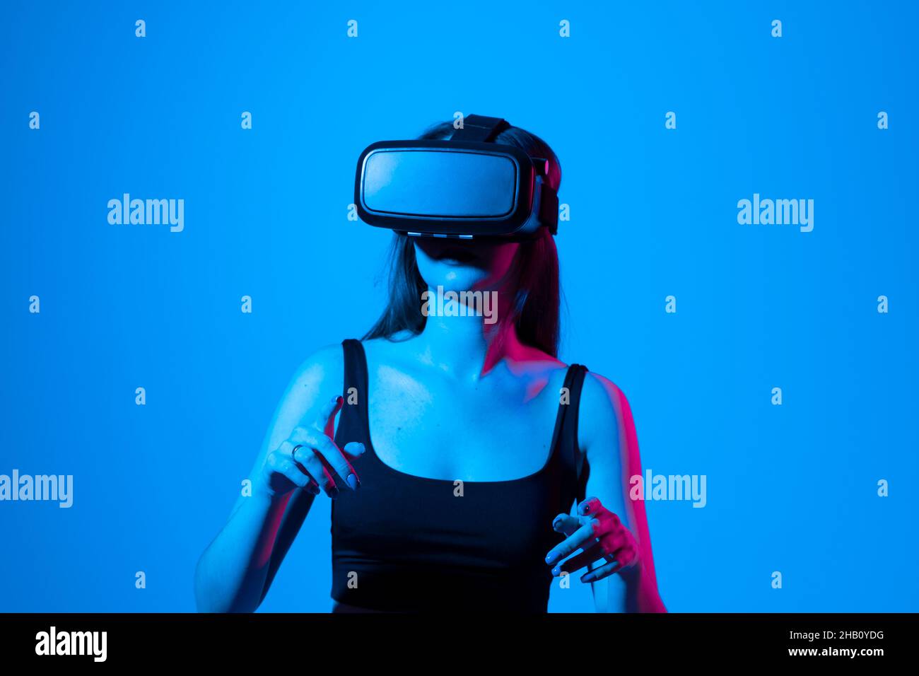 Young Woman Using Vr Headset Helmet To Interacts With Metaverse Using