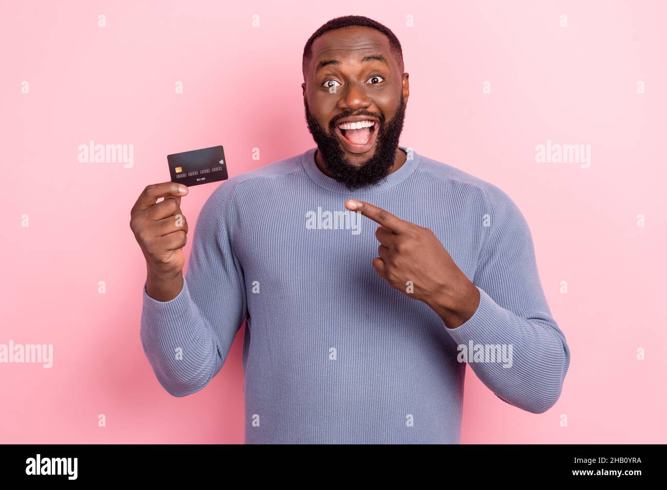 Photo of funny glad man direct forefinger debit card advertise cashback ...