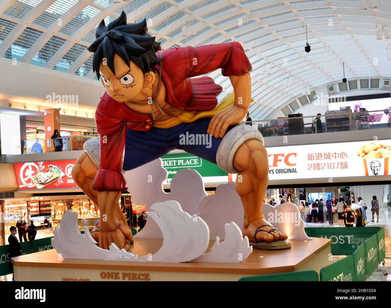 On podium inside a shopping arcade displays a large inflatable figure ...
