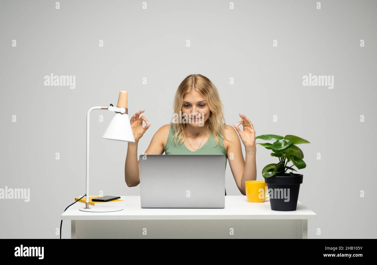 Picture of happy young lady chatting by laptop computer looking on a ...