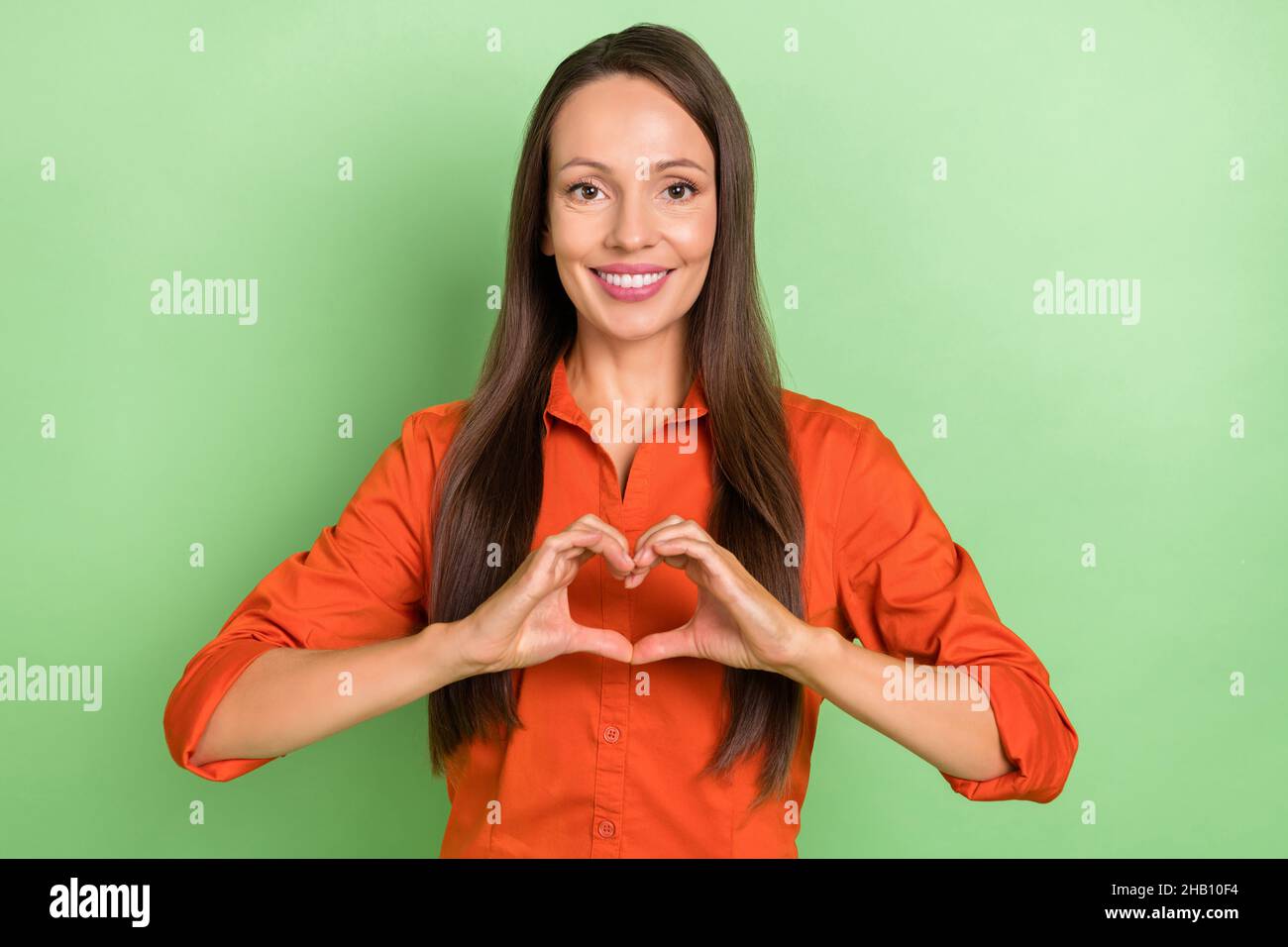 Photo of young cheerful woman show hands small heart symbol romantic ...
