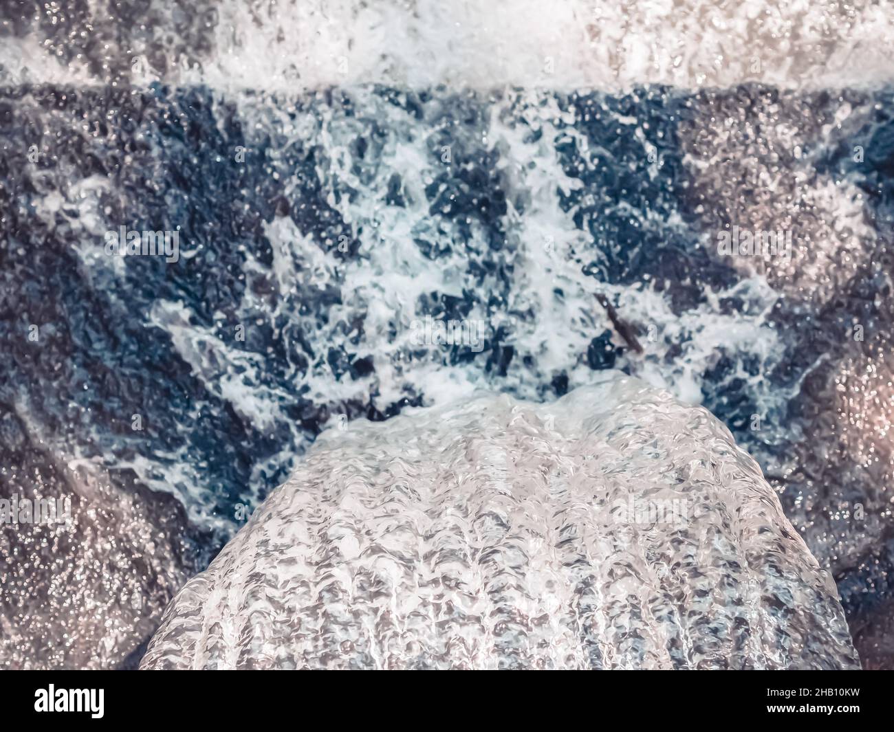 A stormy stream of clear water flowing down from top to bottom. Full ...