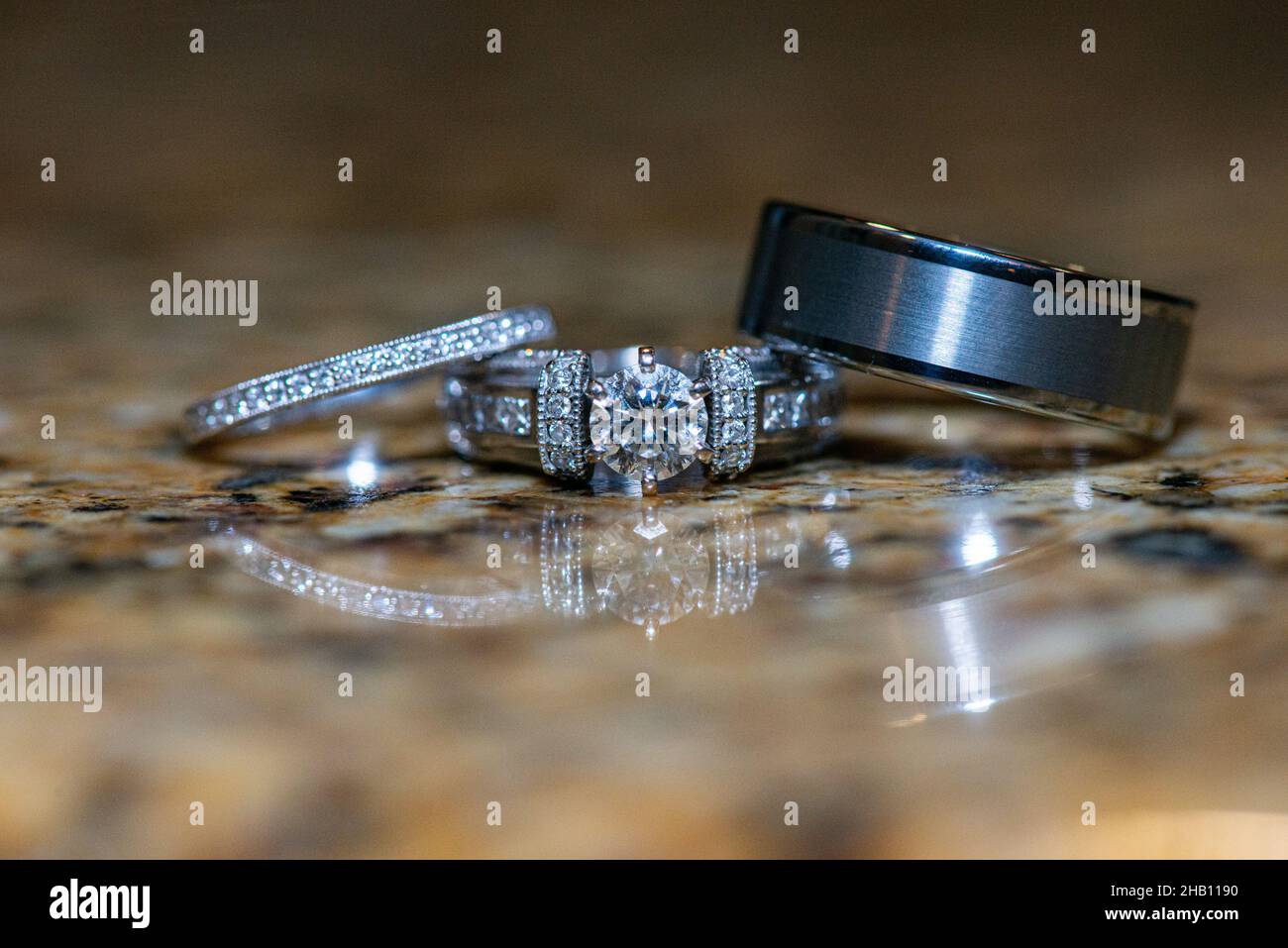 white gold wedding rings with diamonds on Granite countertop Stock ...