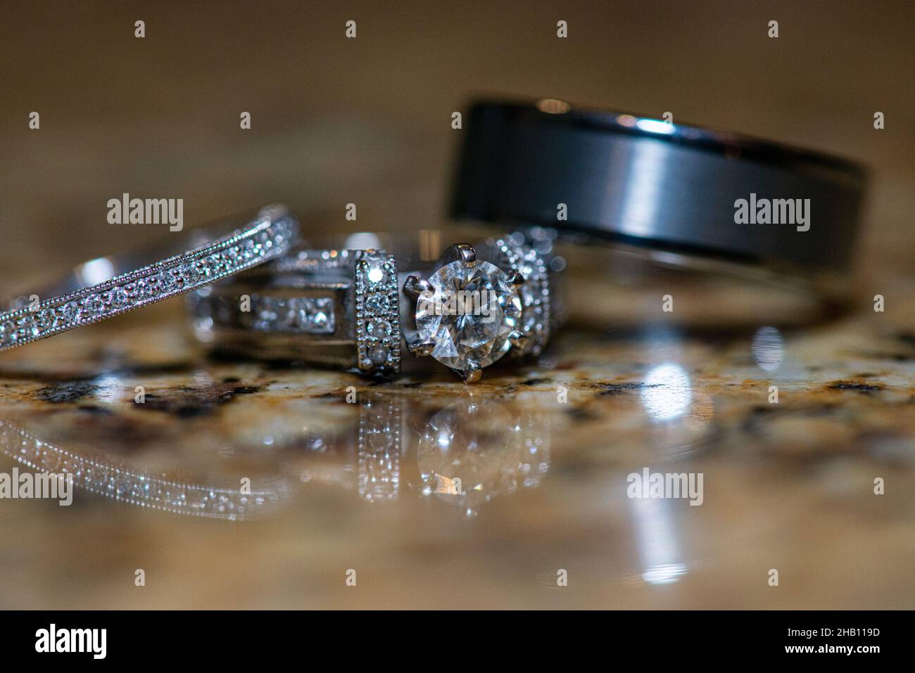 white gold wedding rings with diamonds on Granite countertop Stock ...
