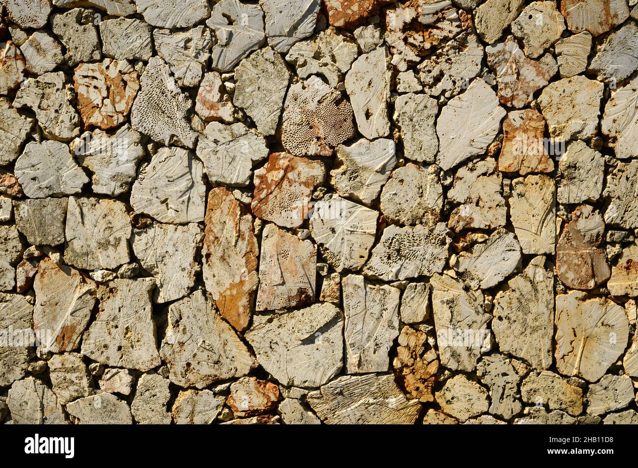 The photo shows a stone wall; the delimitation of the natural stone of ...