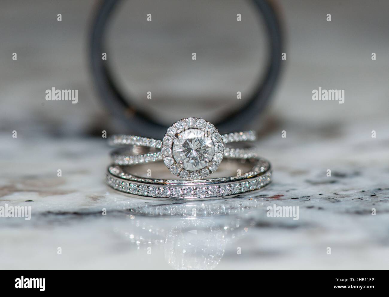 White gold bride and grooms wedding rings with diamonds on reflective white granite Stock Photo ...