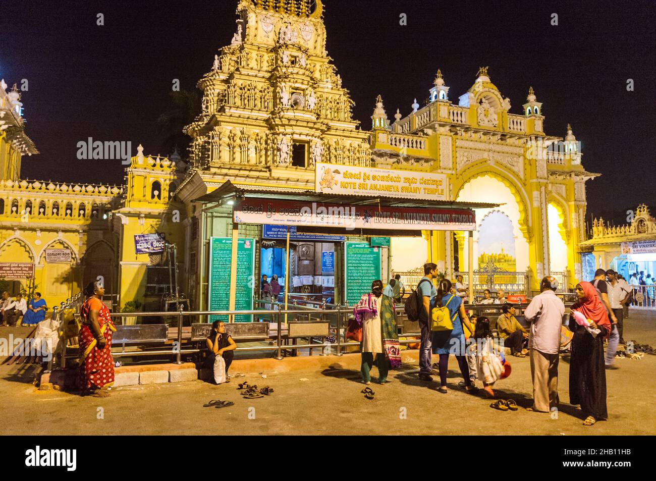 Mysore, Karnataka, India : People stand at night outside the temple at ...