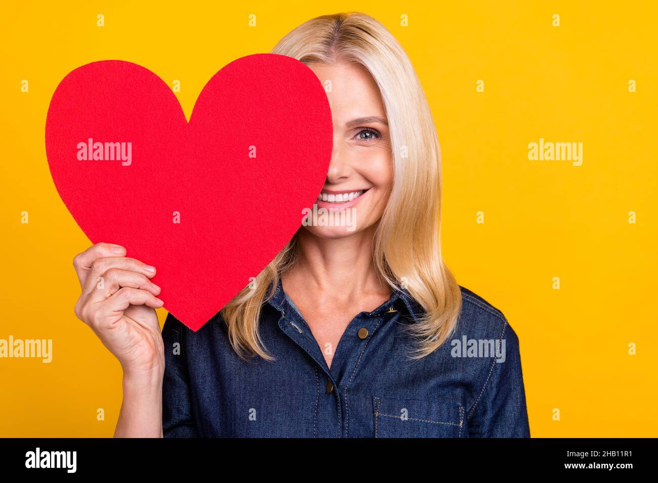 Photo of sweet shy lady pensioner dressed denim outfit big red heart ...
