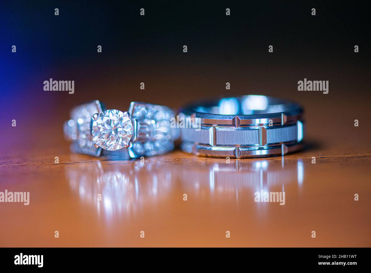 white gold wedding ring with diamonds side by side on wood surface ...