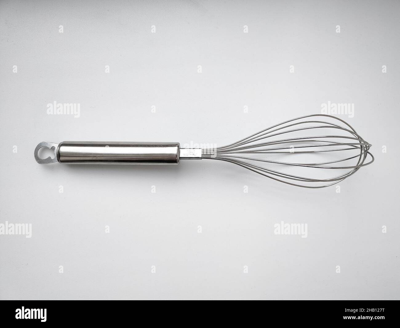 Stainless steel metal culinary whisk on white background. Kitchen ...