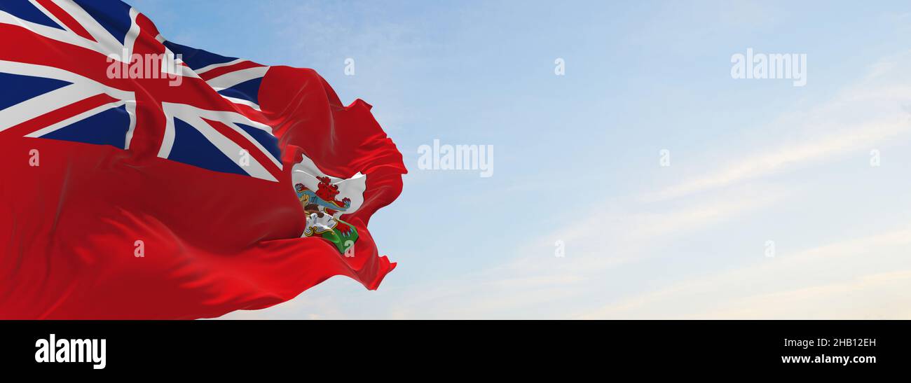 official flag of Bermuda at cloudy sky background on sunset, panoramic ...