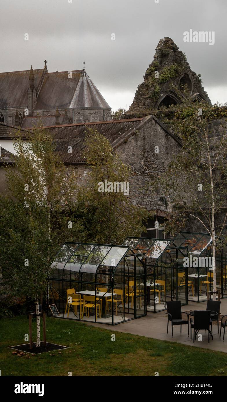 Eerie scenery of a small modern cafe under a majestic medieval castle ...