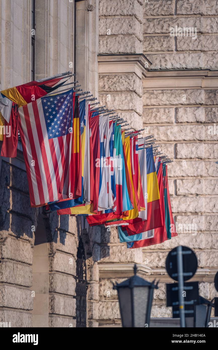 Vertical shot of national flags of many countries attached to a ...