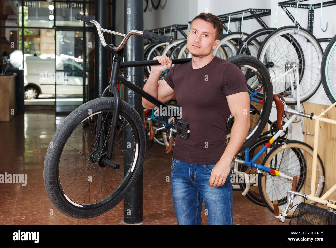 Portrait man standing bike shop hi-res stock photography and images - Alamy