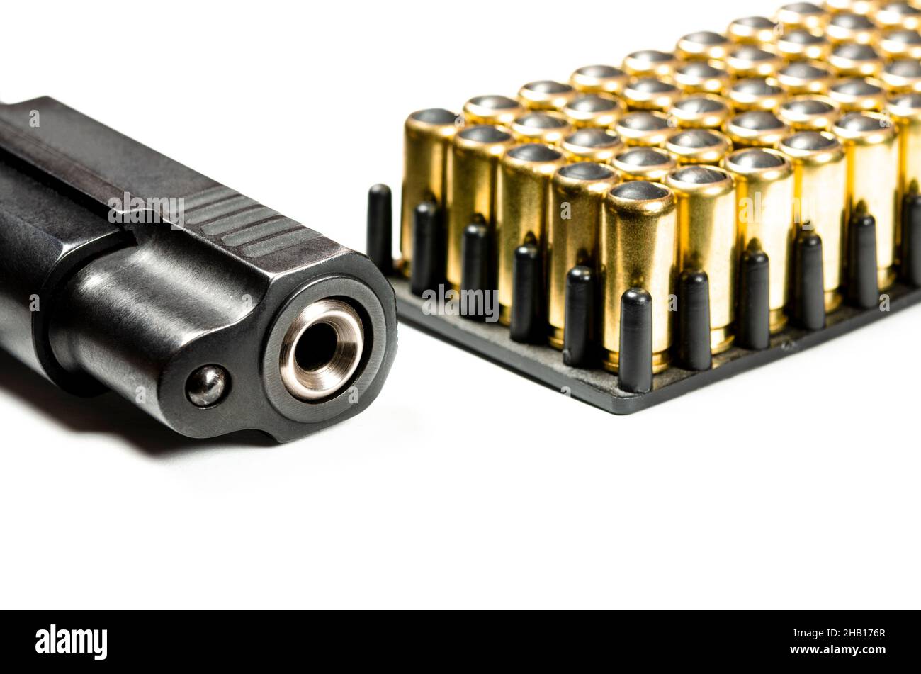photo of a black pistol and bullets on a white background. Weapons ...