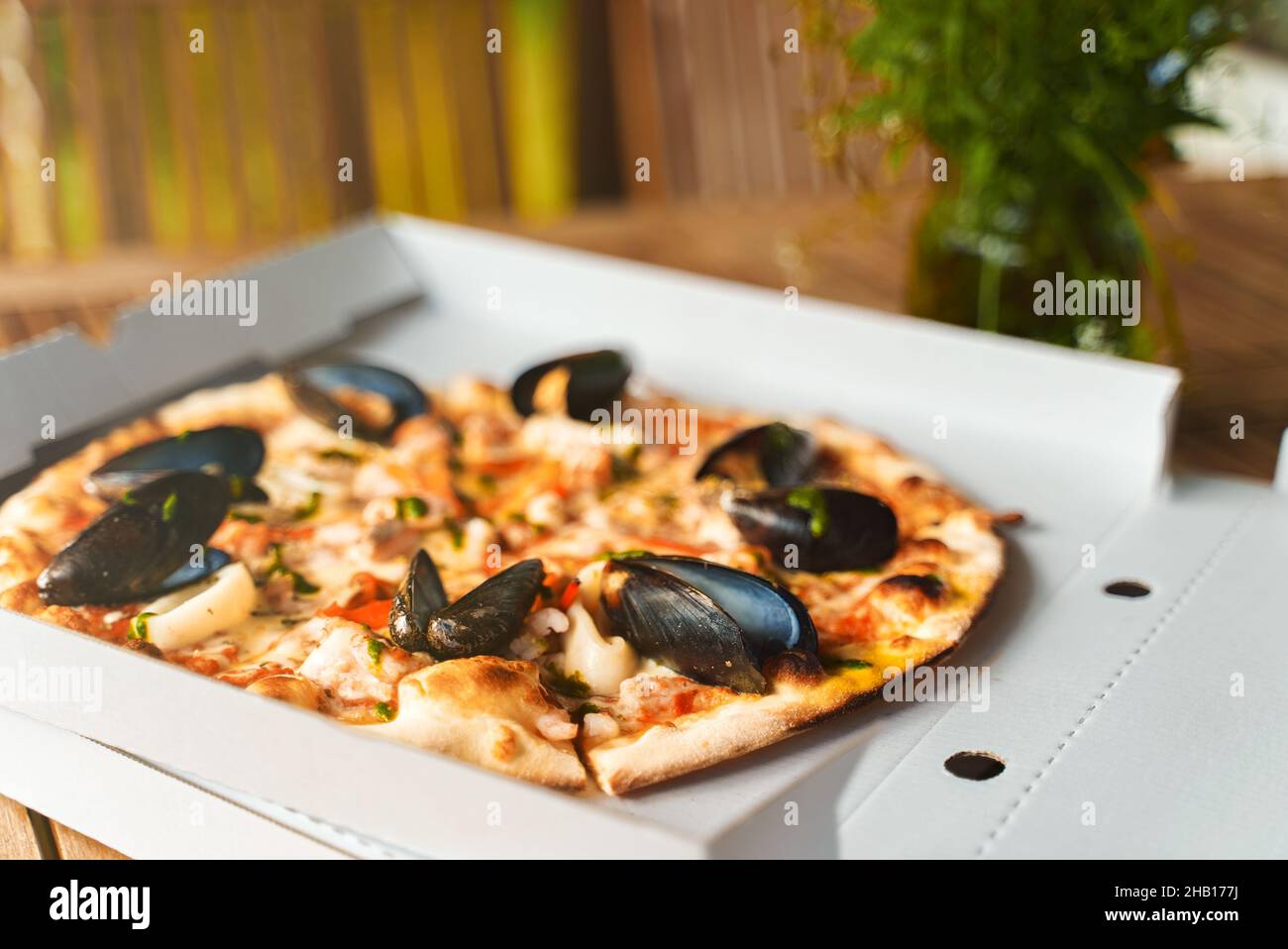 Crispy seafood pizza with mussels, squid and shrimps Stock Photo - Alamy