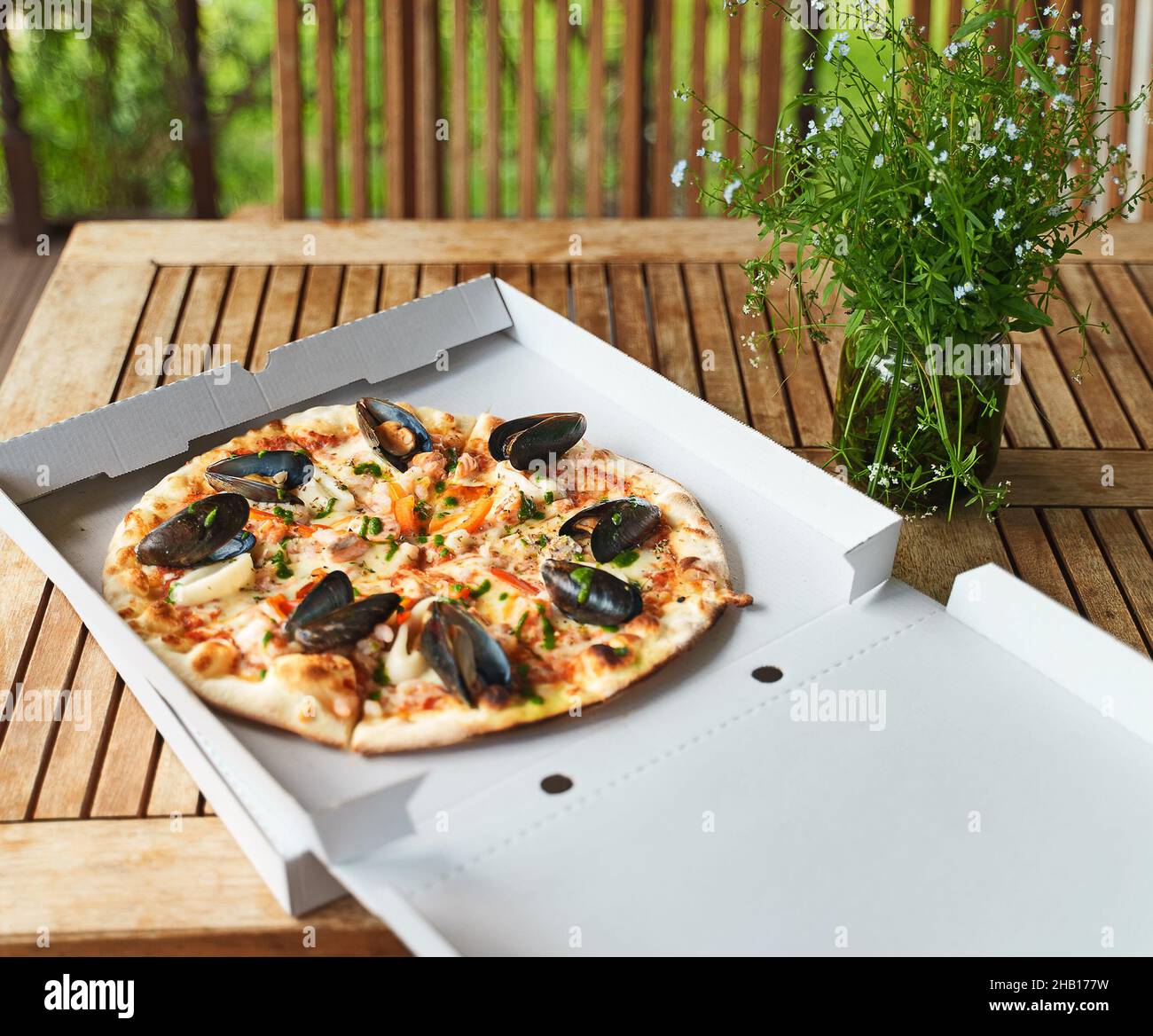 Crispy seafood pizza with mussels, squid and shrimps Stock Photo - Alamy