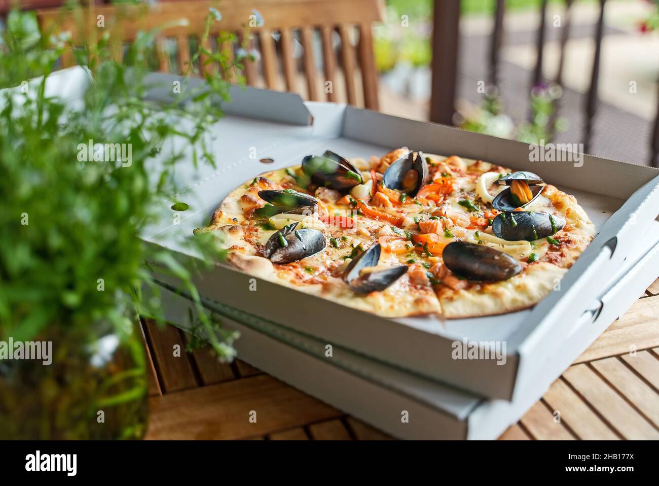 Crispy seafood pizza with mussels, squid and shrimps Stock Photo - Alamy