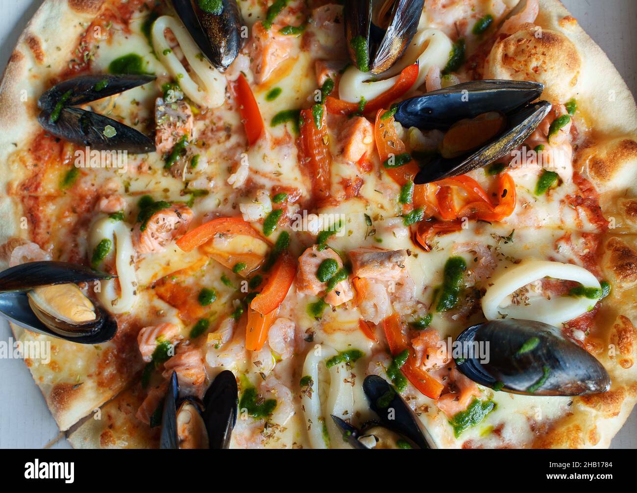 Crispy seafood pizza with mussels, squid and shrimps Stock Photo - Alamy