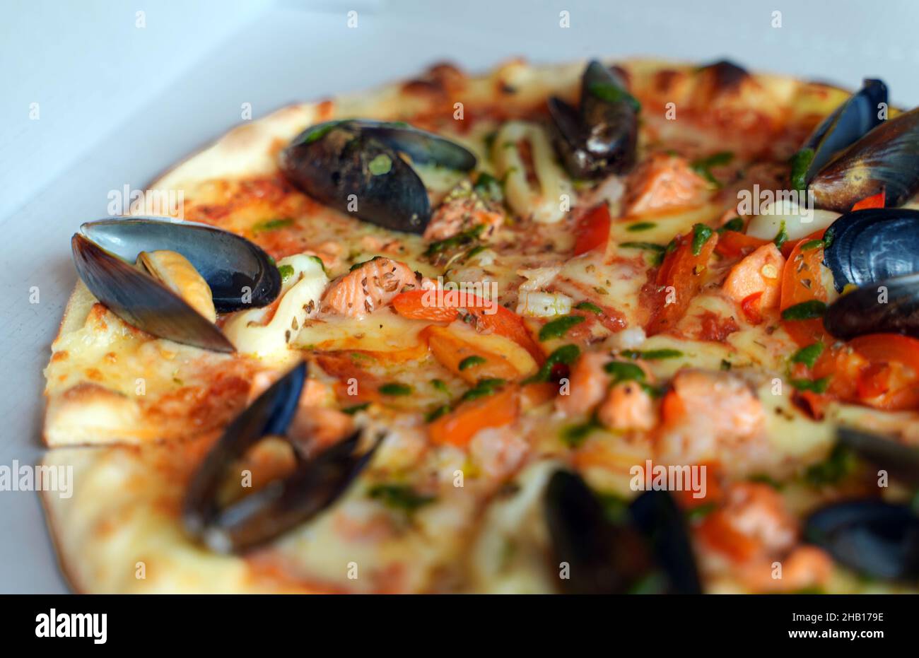 Crispy seafood pizza with mussels, squid and shrimps Stock Photo - Alamy
