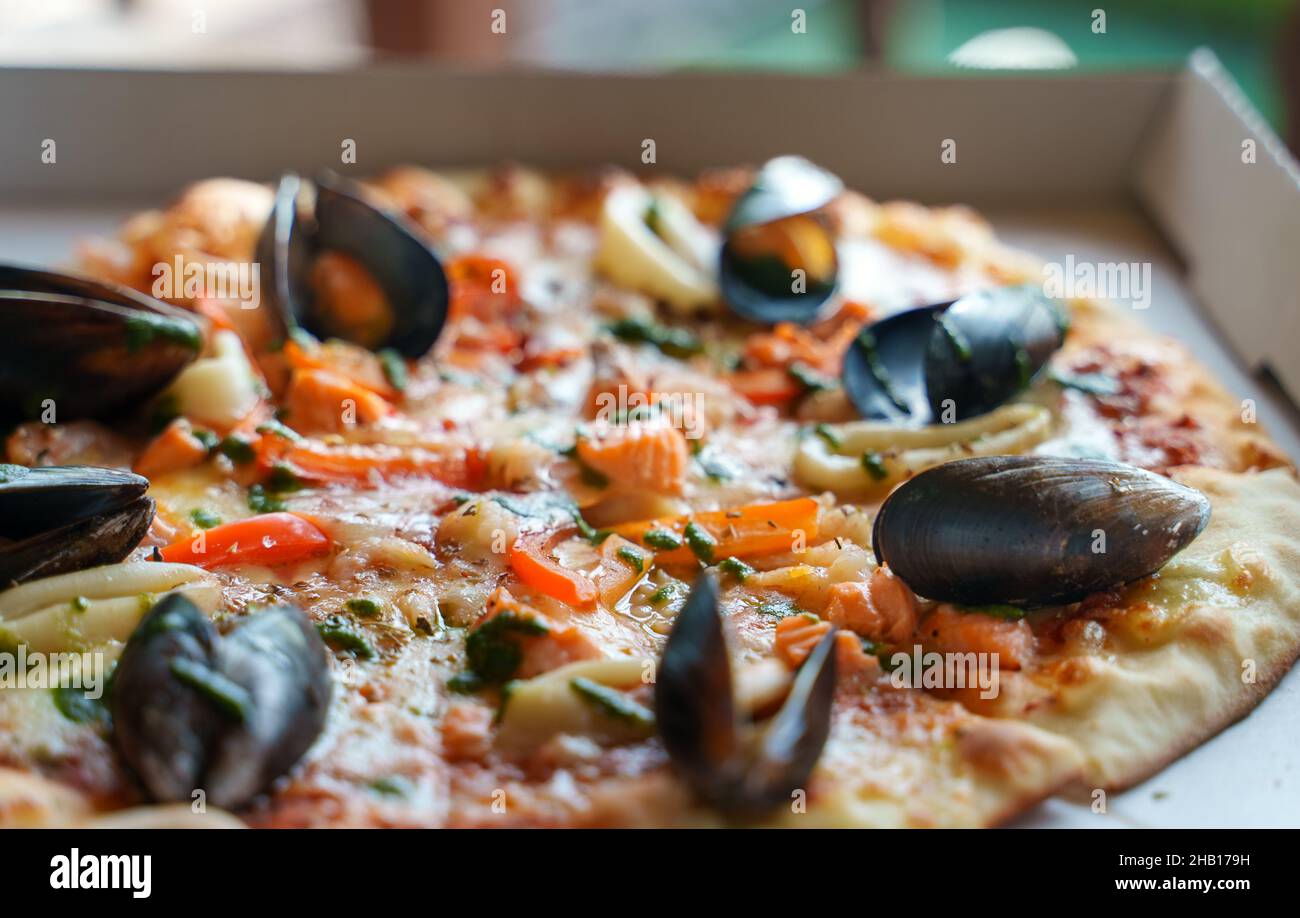 Crispy seafood pizza with mussels, squid and shrimps Stock Photo - Alamy