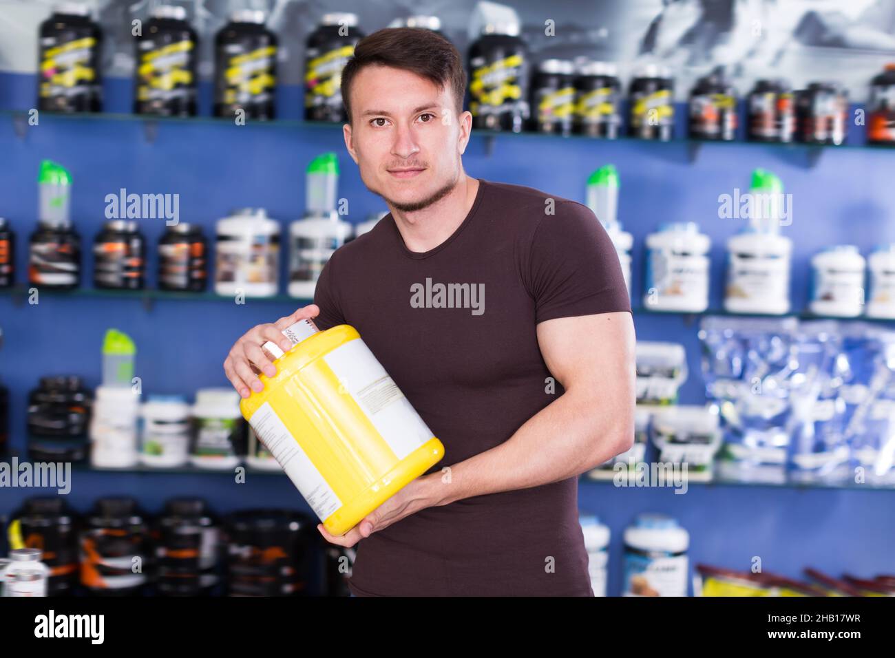 Portrait of sports guy with sport nutrition Stock Photo - Alamy