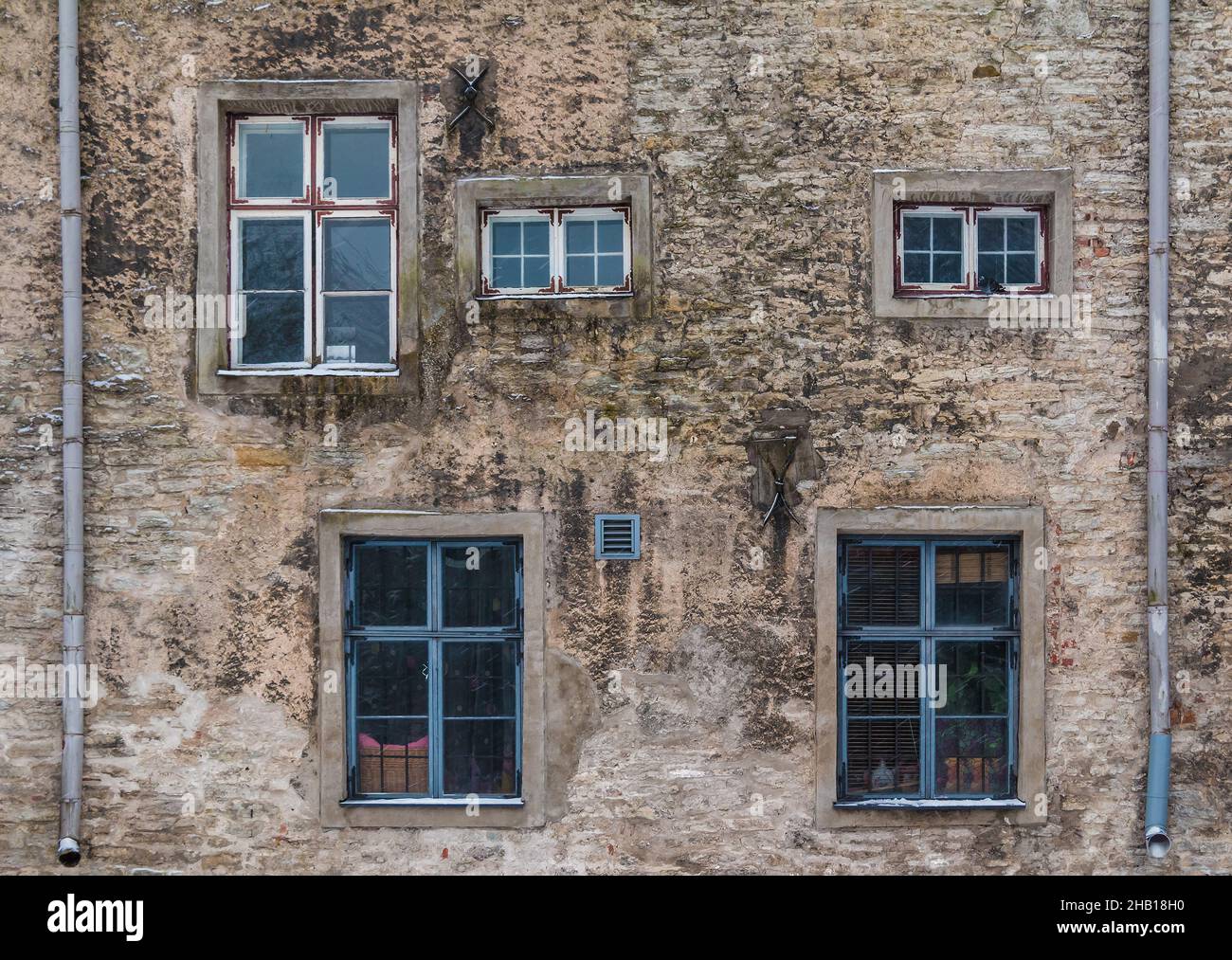 Several windows on facade of the urban historic building front view ...