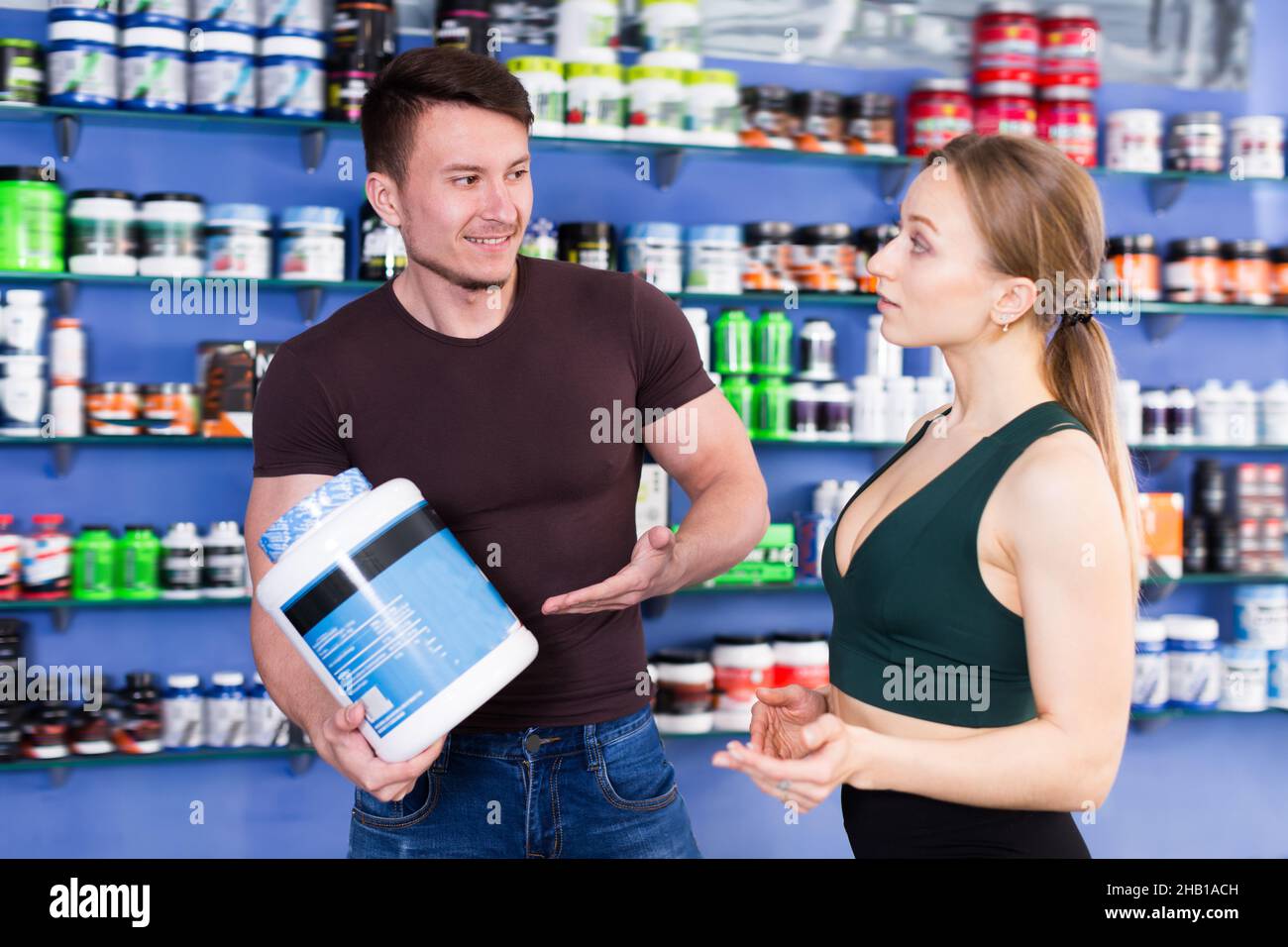 Joyful people discussing in shop interior Stock Photo - Alamy