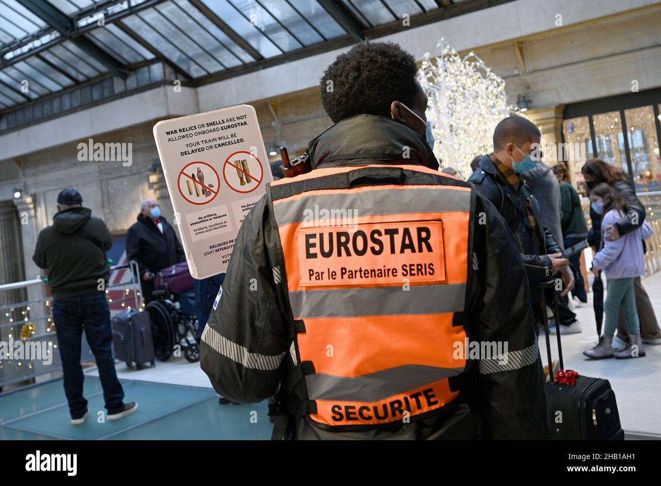 A Eurostar security agent holds a panel to remind passengers traveling ...