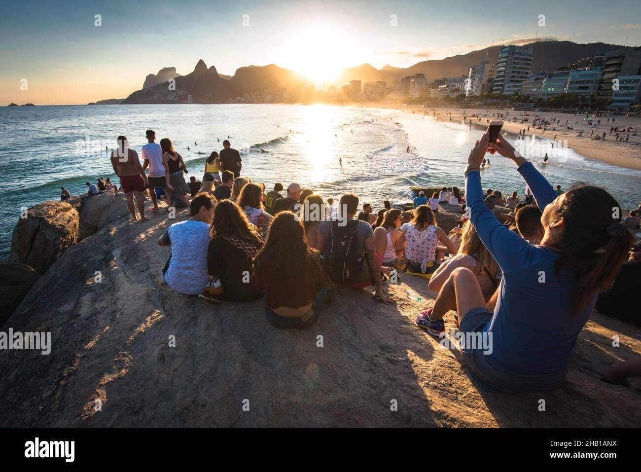 Rio de Janeiro, Brazil - August 18, 2018: People sitting all around on ...