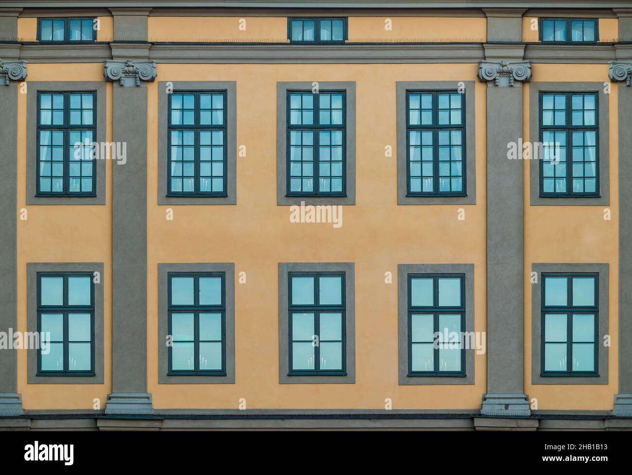 Many windows on facade of the urban historic building front view ...