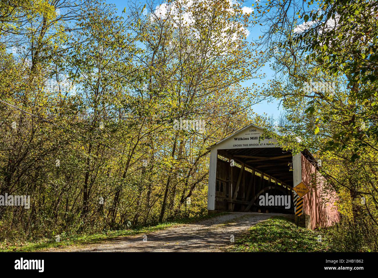 The Wilkins Mill Covered Bridge crosses Sugar Creek during Autumn leaf ...