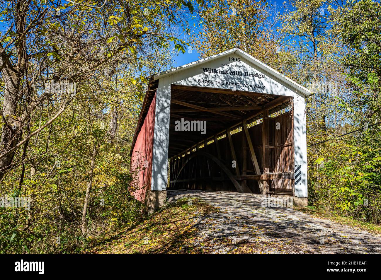 The Wilkins Mill Covered Bridge crosses Sugar Creek during Autumn leaf ...