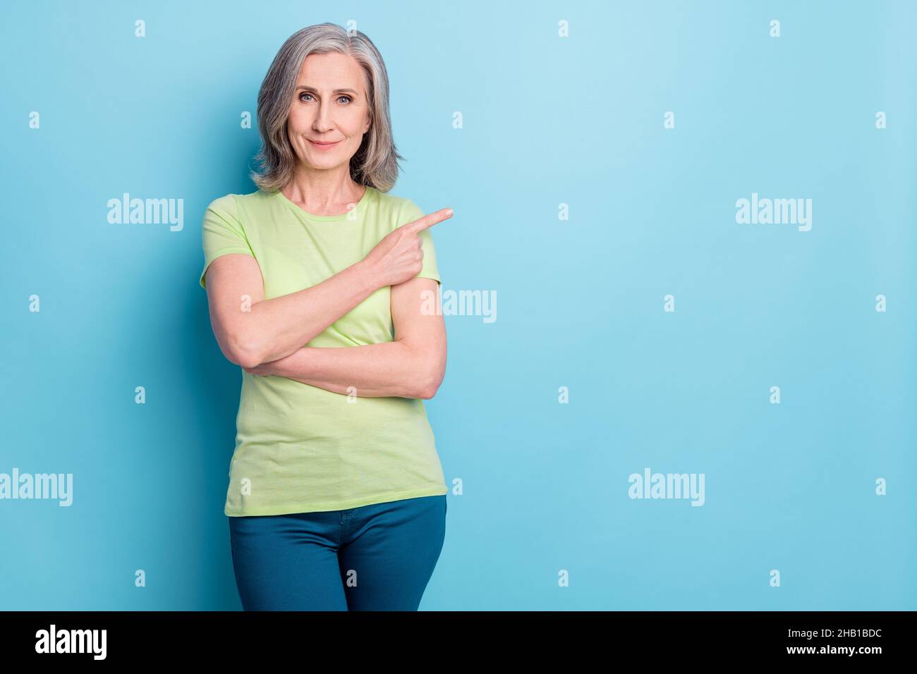 Photo portrait old woman showing finger blank space advising isolated ...