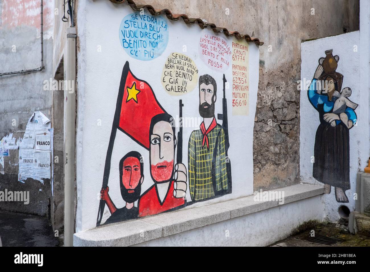A mural is seen on the walls of a building in the village of Orgosolo ...