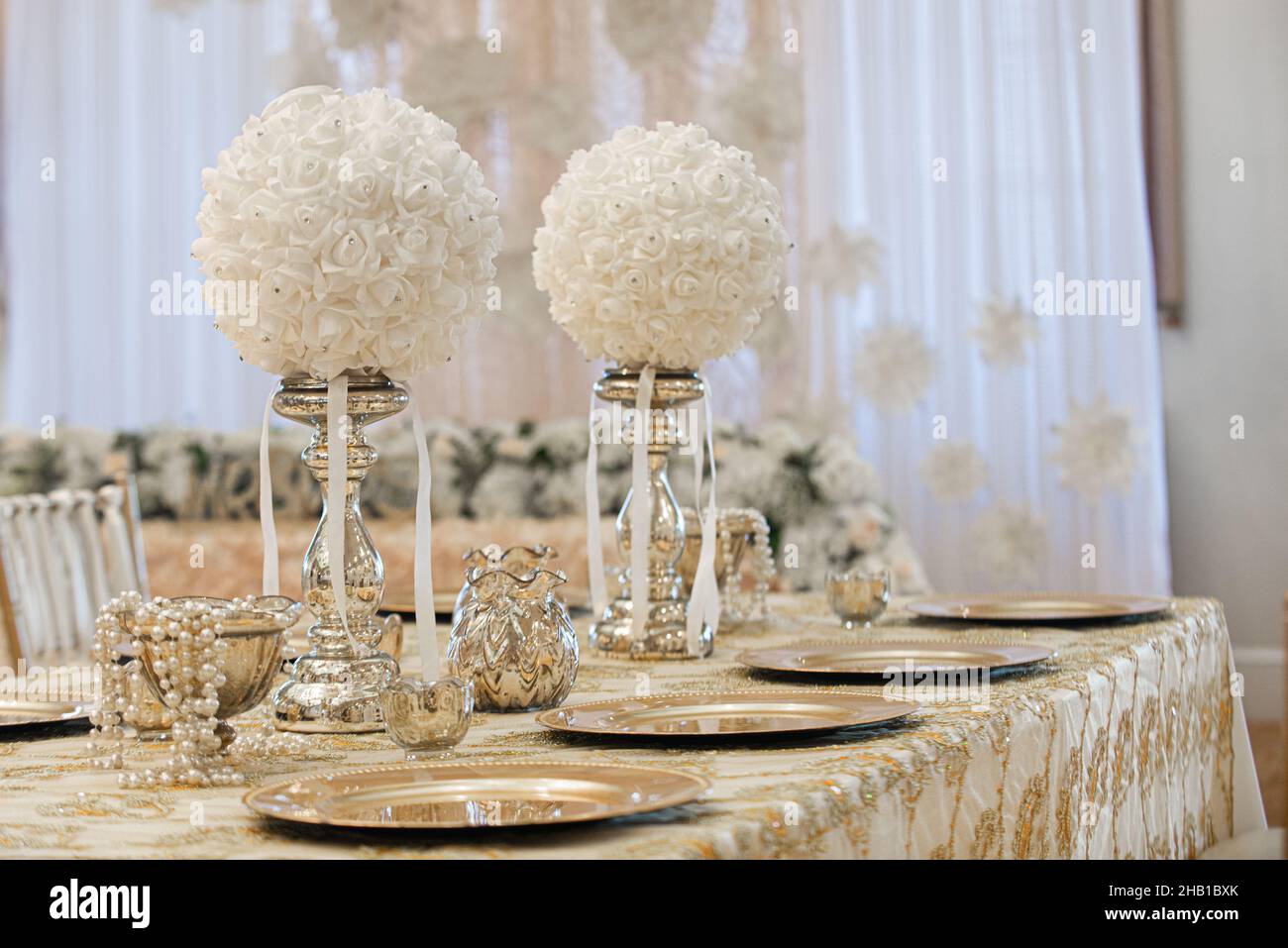 Gold table centerpieces with white ball flowers with diamonds Stock ...