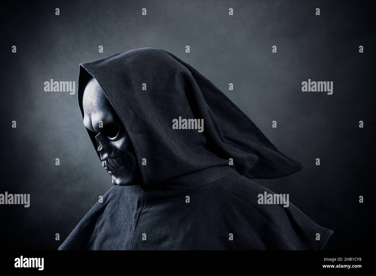 Grim reaper over dark misty background Stock Photo - Alamy