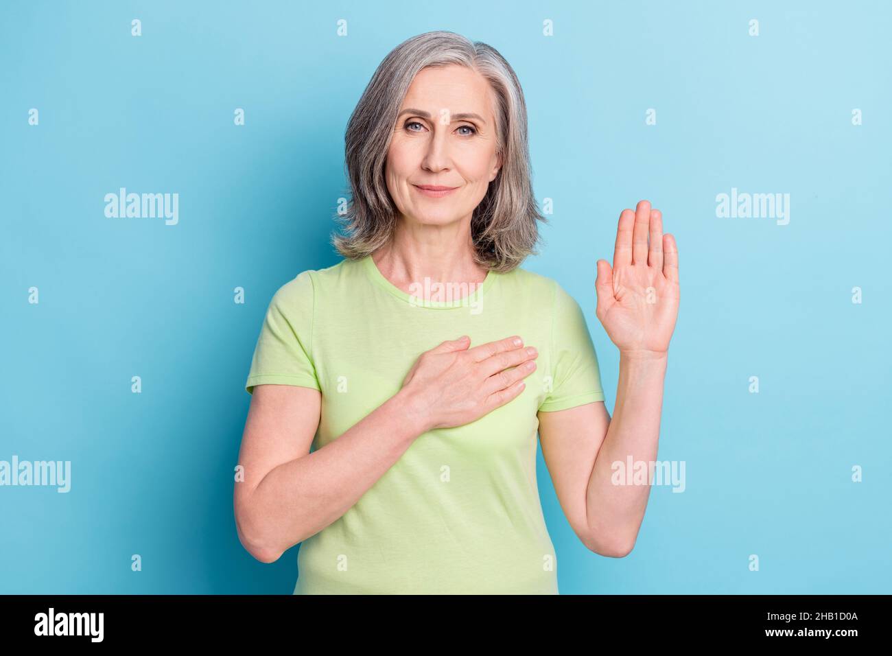 Photo of charming positive happy old woman hold hand chest make pledge ...