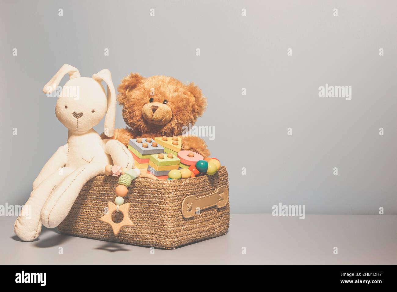 Toy box full of baby kid toys. Container with teddy bear, wooden ...