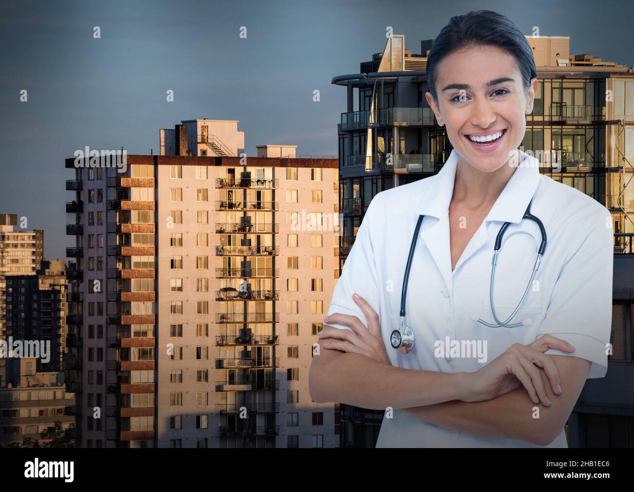 Composite image of caucasian female doctor against tall buildings in ...