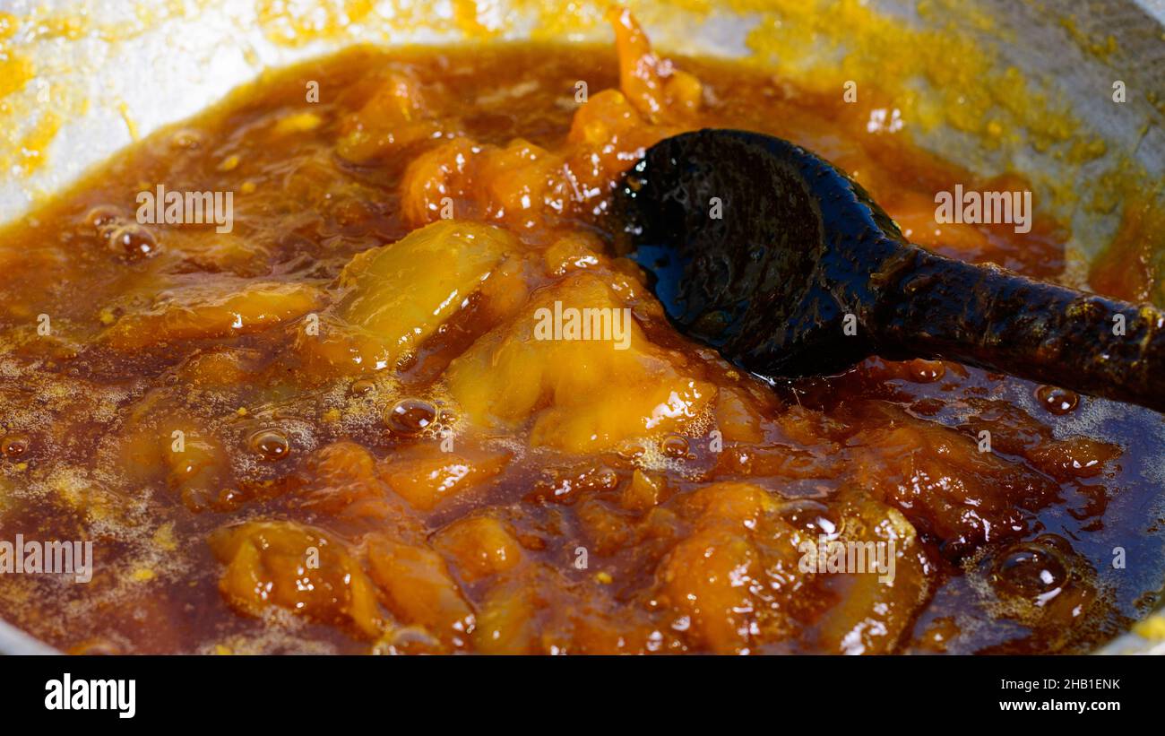 making mango jam, boiling mango pieces with sugar syrup, homemade sweet ...