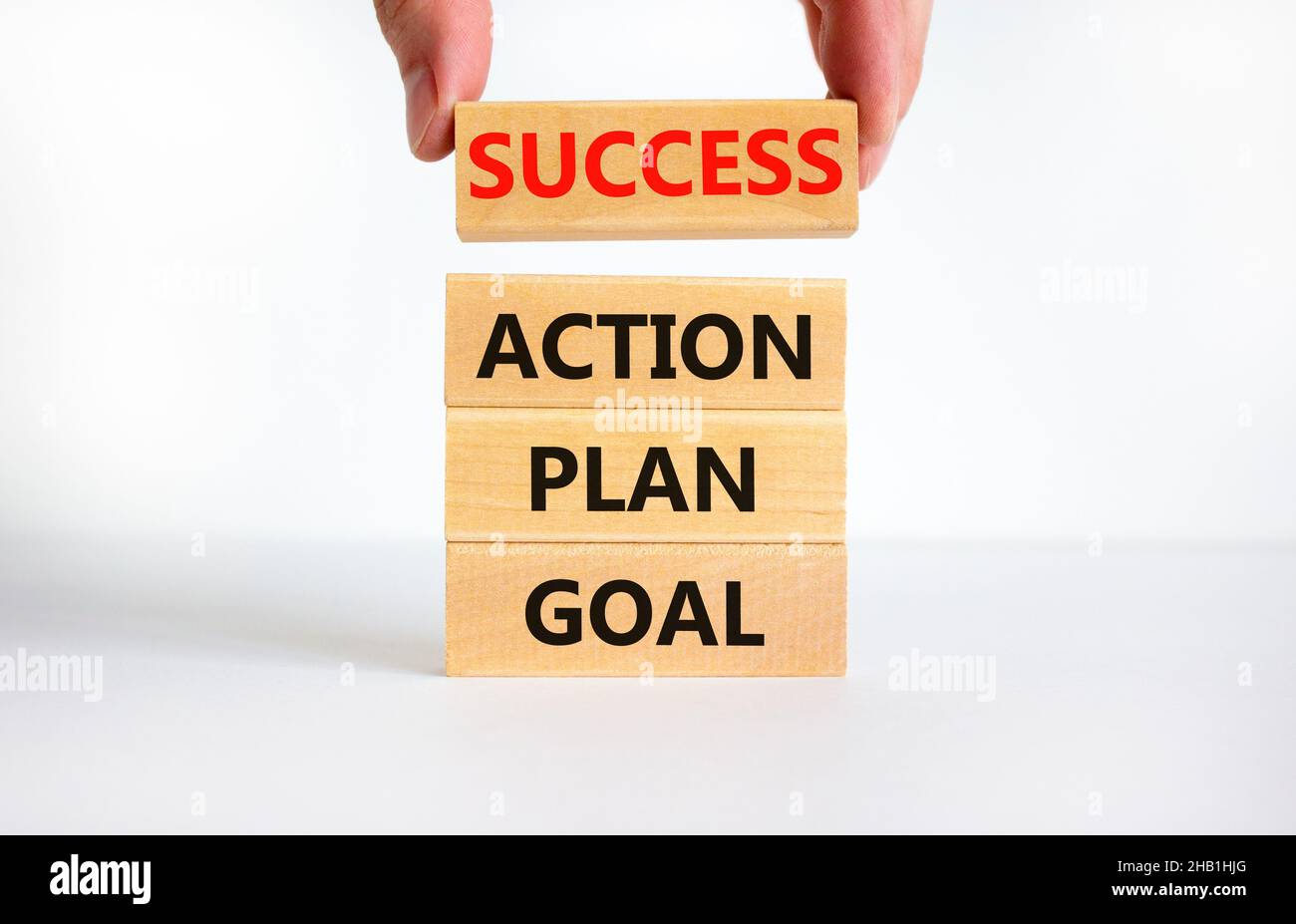 Goal plan action success symbol. Concept words Goal plan action success on blocks. Businessman ...