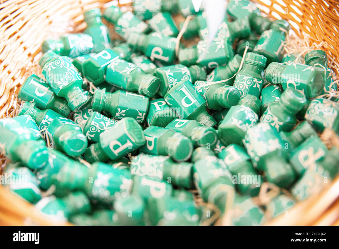 Basket full of green bubble bottles with the letter "p" printed on them ...